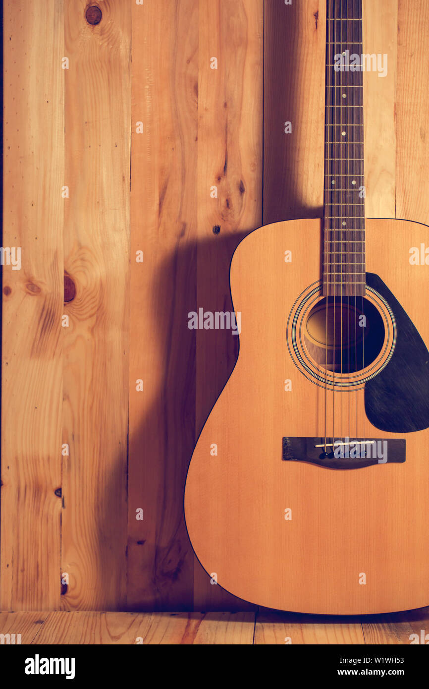 Acoustic guitar on wood background Stock Photo - Alamy