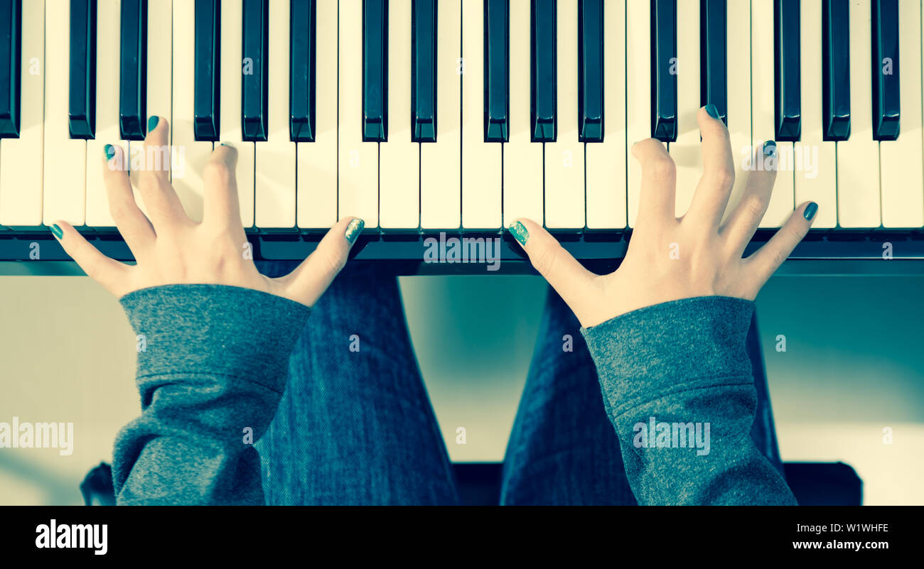 Closeup woman's hand playing piano. Top view Stock Photo - Alamy