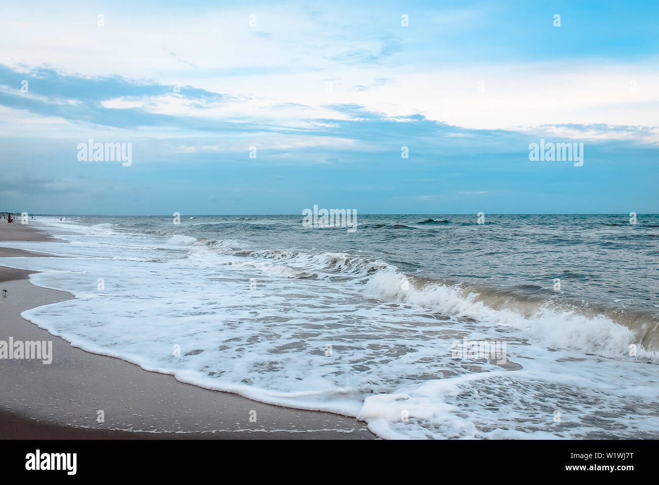 calm waves at Ocean Isle during low tide Stock Photo - Alamy