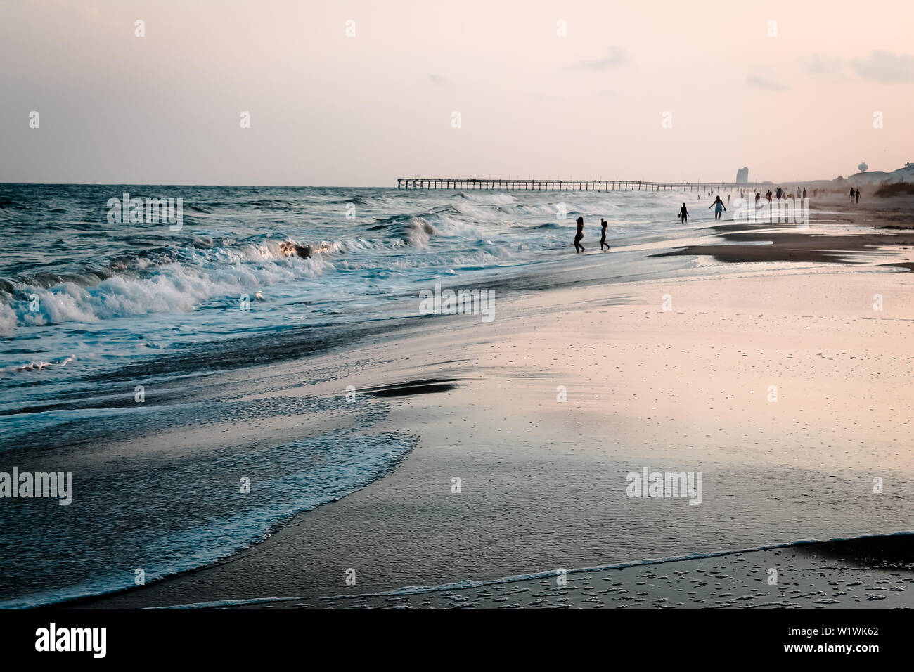 Tourist enjoying the Atlantic Ocean at Ocean Isle Beach North Carolina ...