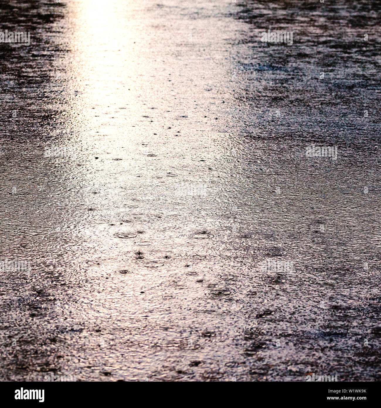 Raindrops falling on puddle hi-res stock photography and images - Alamy