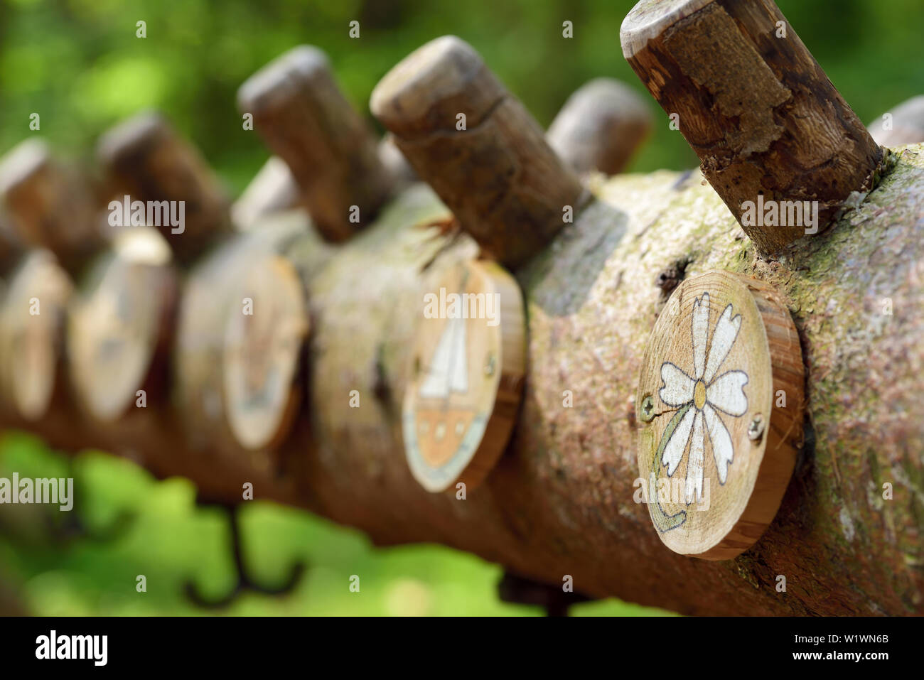 Rustic wardrobe with coat hooks and colorful simple name tags in the ...