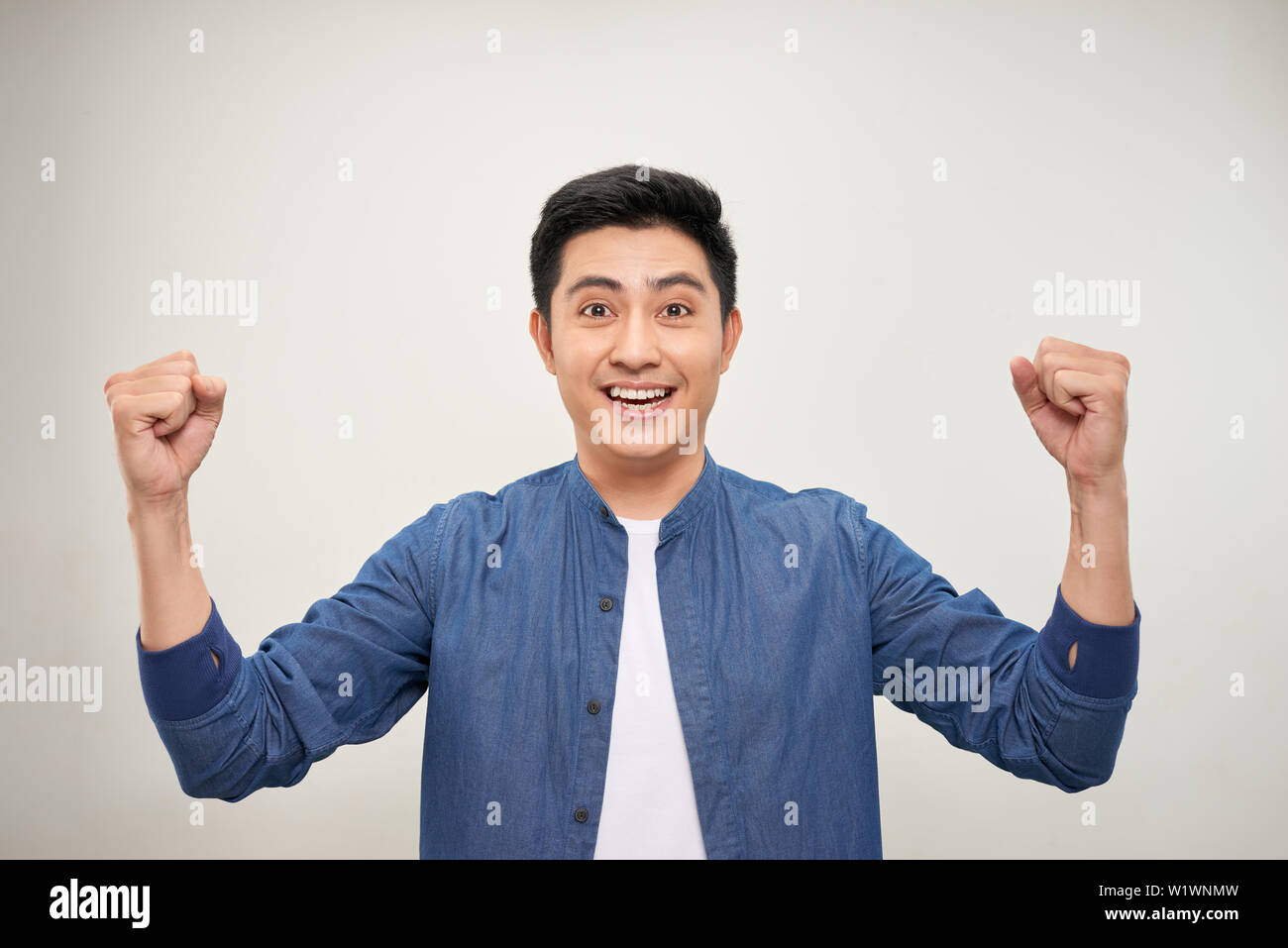 Cool asian man winner sign Stock Photo - Alamy