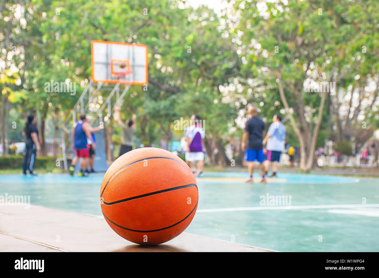 Basketball on the wooden chair Background Blurry image of people ...