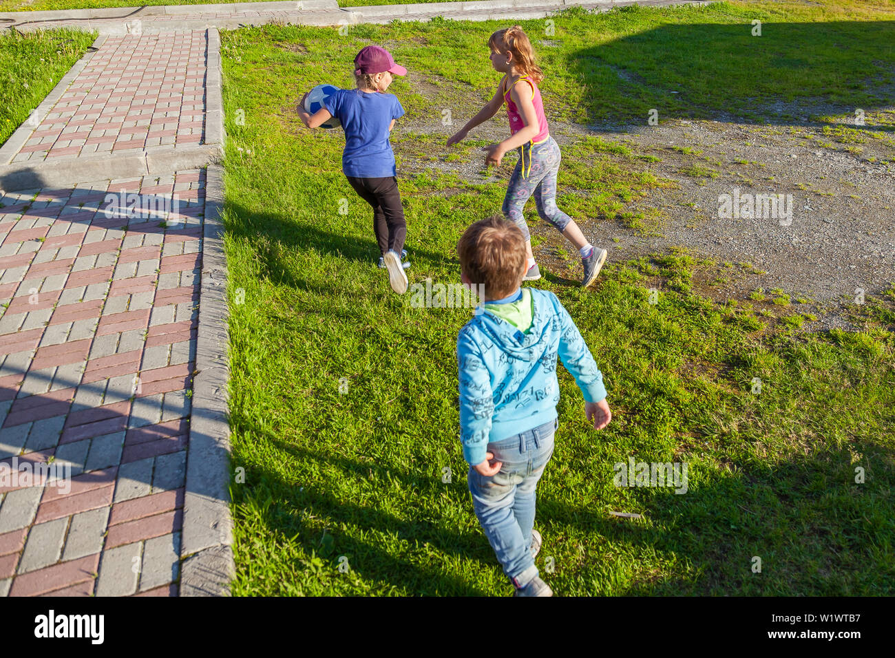 Altai, Russia - 07.02.2019: Three small children, two girls and one boy ...