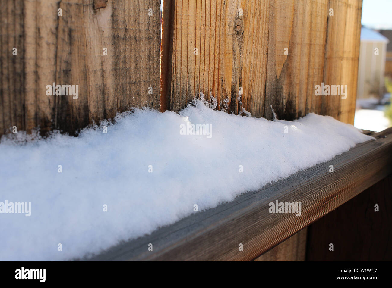 Snow on a fence Stock Photo - Alamy