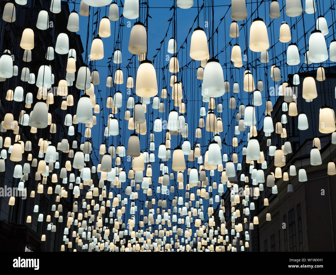 Beautiful bell-shaped lamps street illumination. Blue and yellow ...