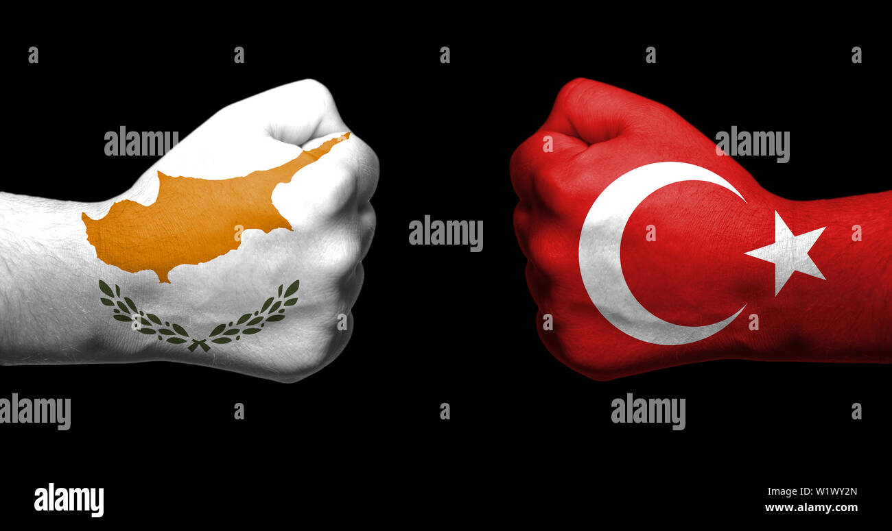 Flags of Turkey and Cyprus painted on two clenched fists facing each ...