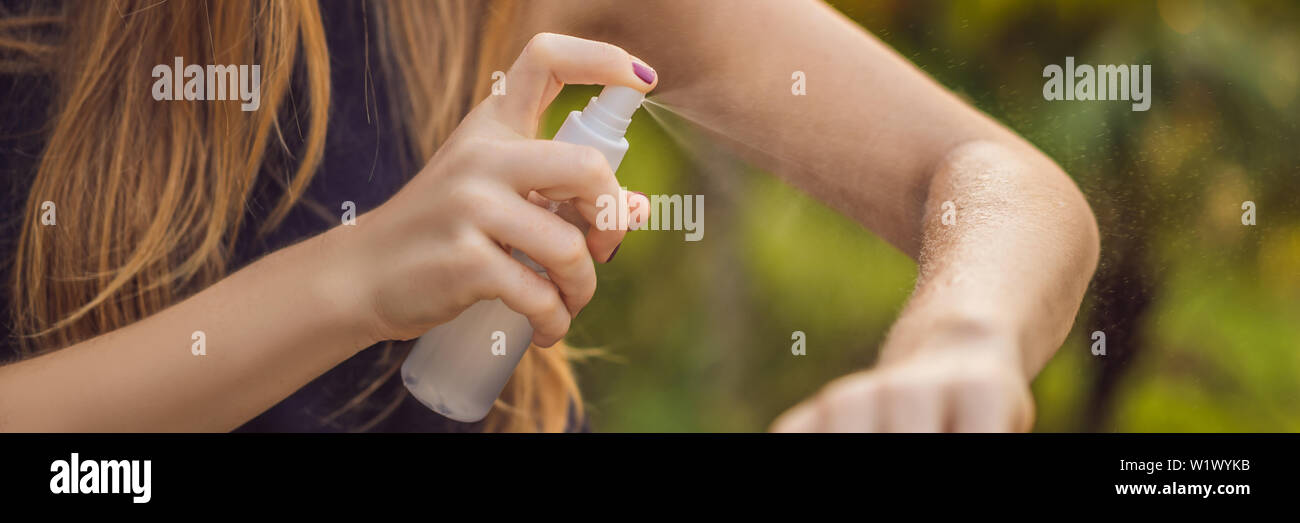 Woman spraying insect repellent on skin outdoor BANNER, LONG FORMAT ...