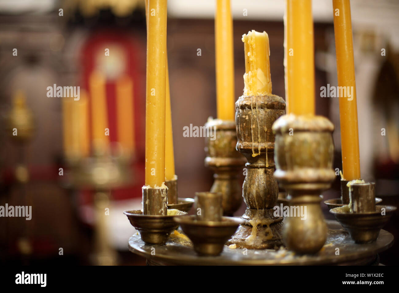 Large wax candles in a candlestick in a Christian church Stock Photo ...