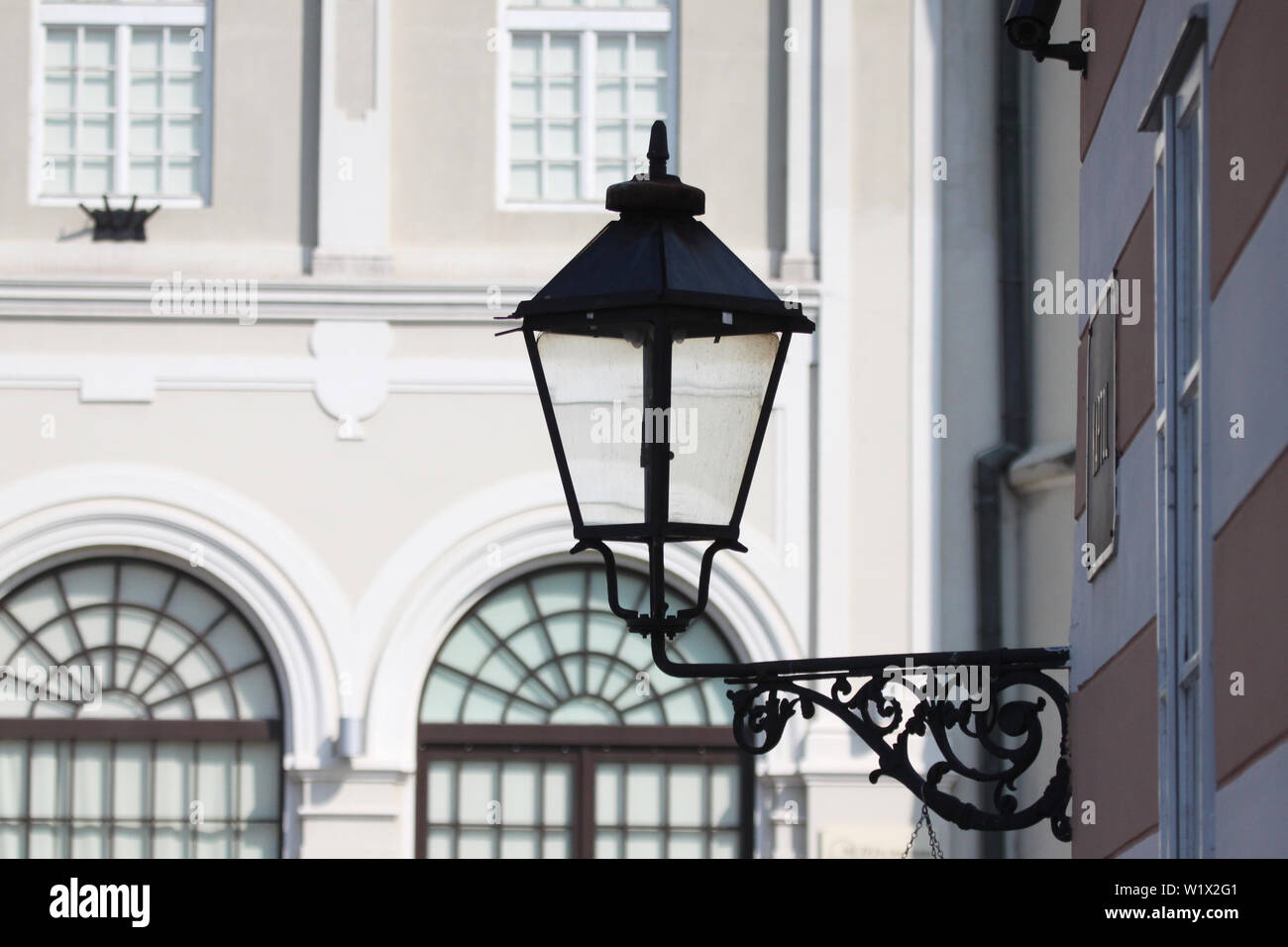 Ancient lantern on the facade of the restored building Stock Photo - Alamy