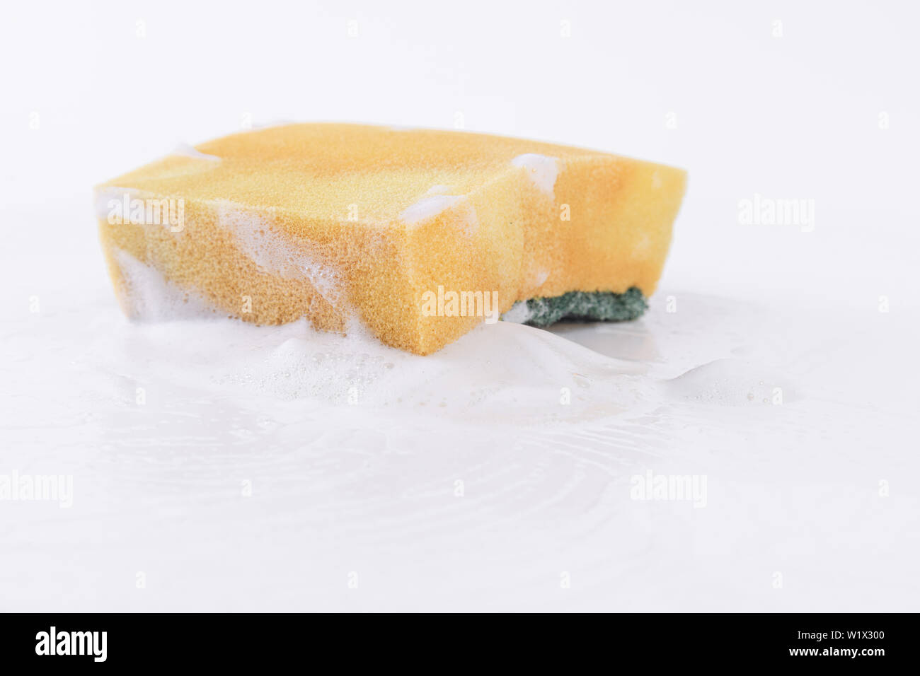 Old dish-washing sponge full of foam on a white background Stock Photo ...
