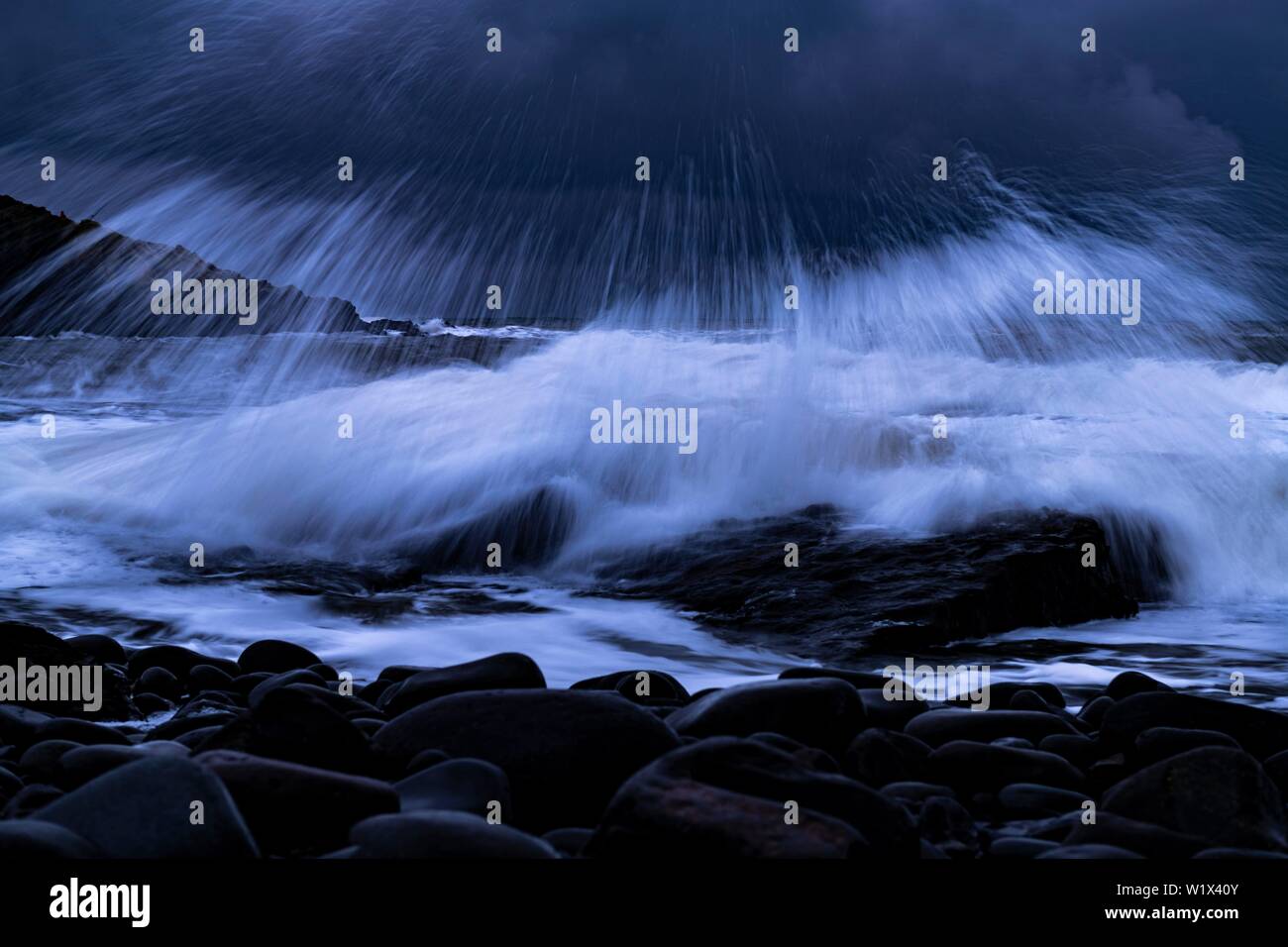 Strong surf on rocky coast, dark cloudy sky, Berwick up on Tweed ...