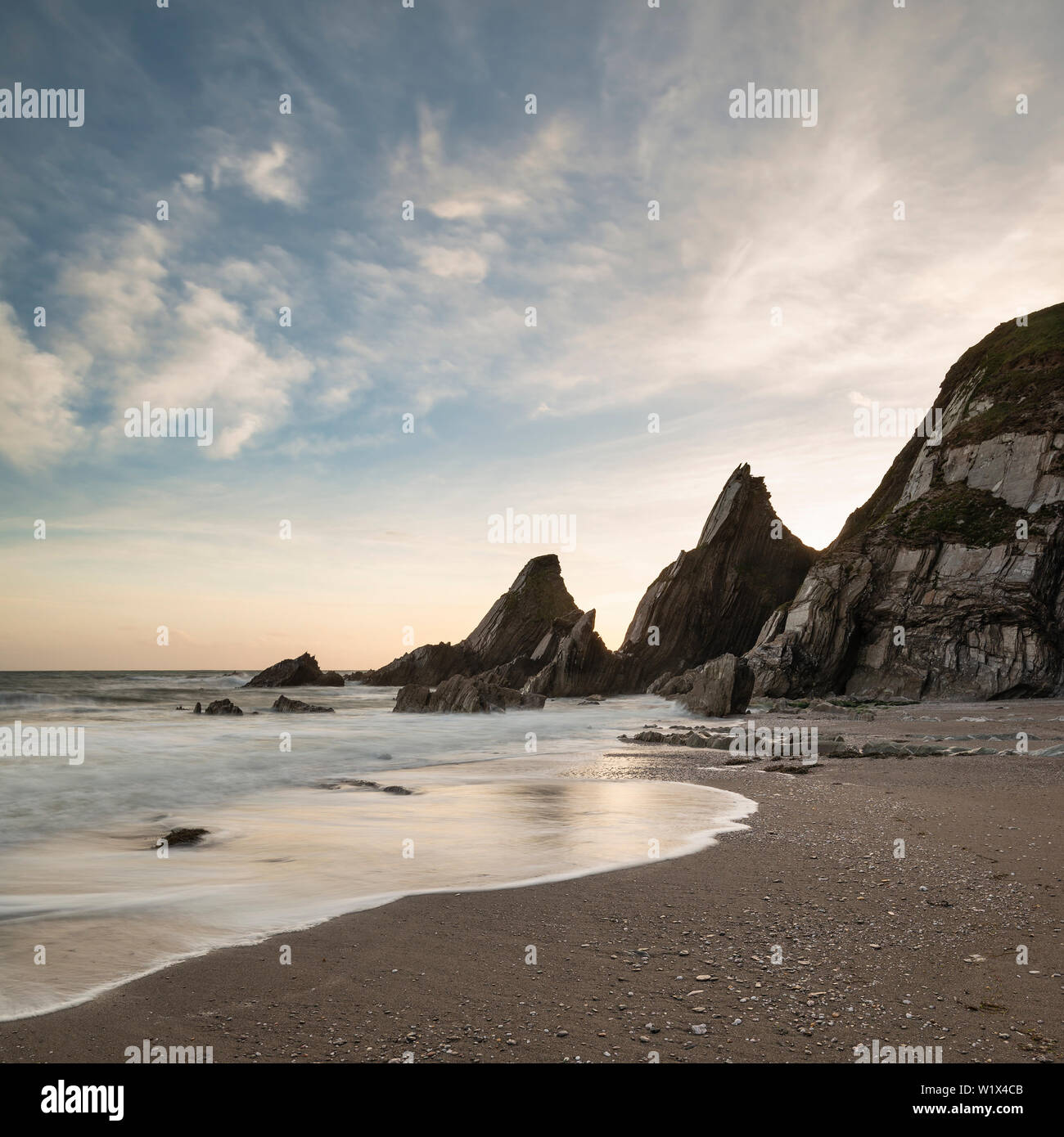 Beautiful sunset landscape image of Westcombe Beach in Devon England ...
