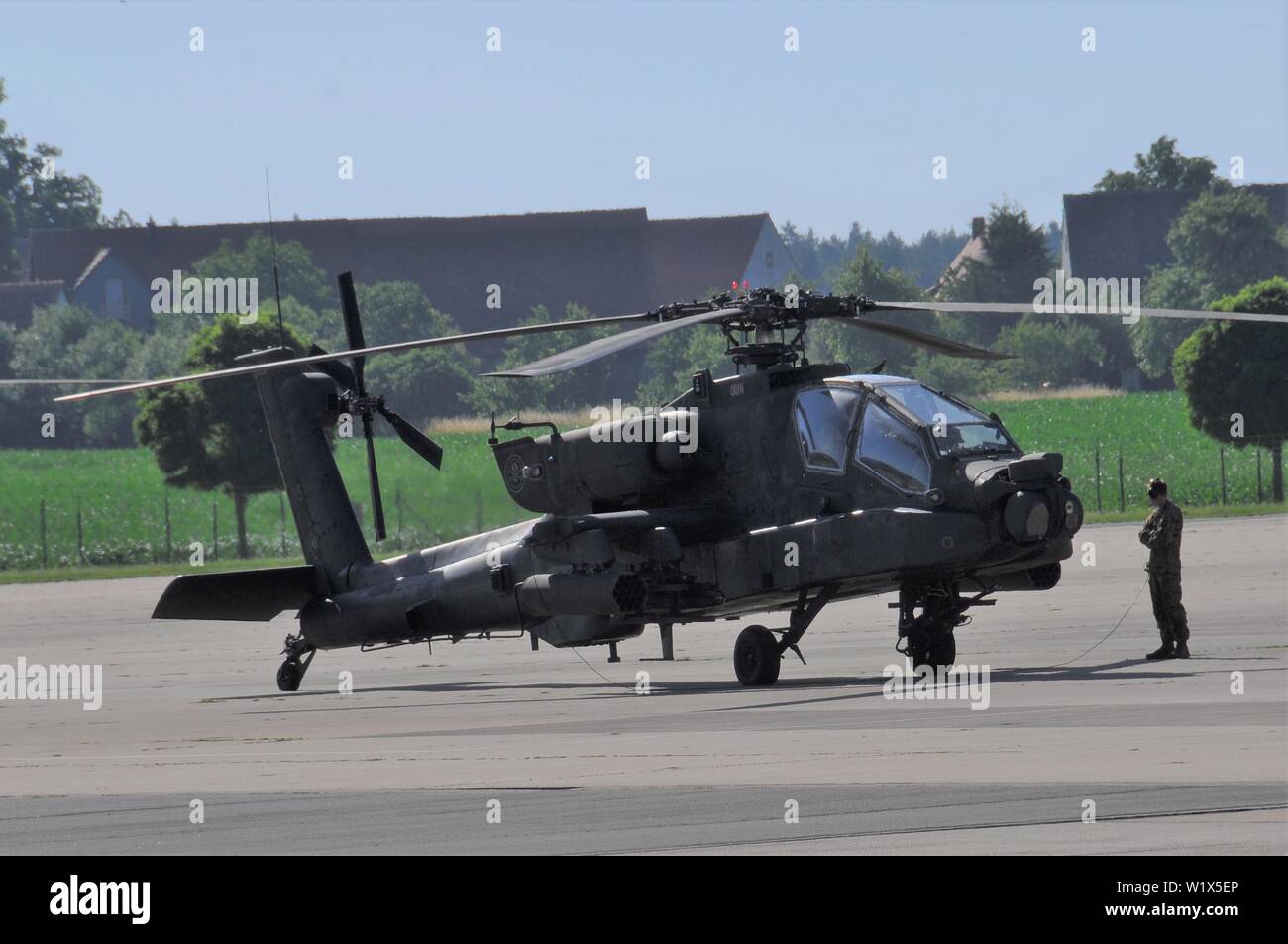 A 12th Combat Aviation Brigade Apache crewmember prefights his aircraft ...