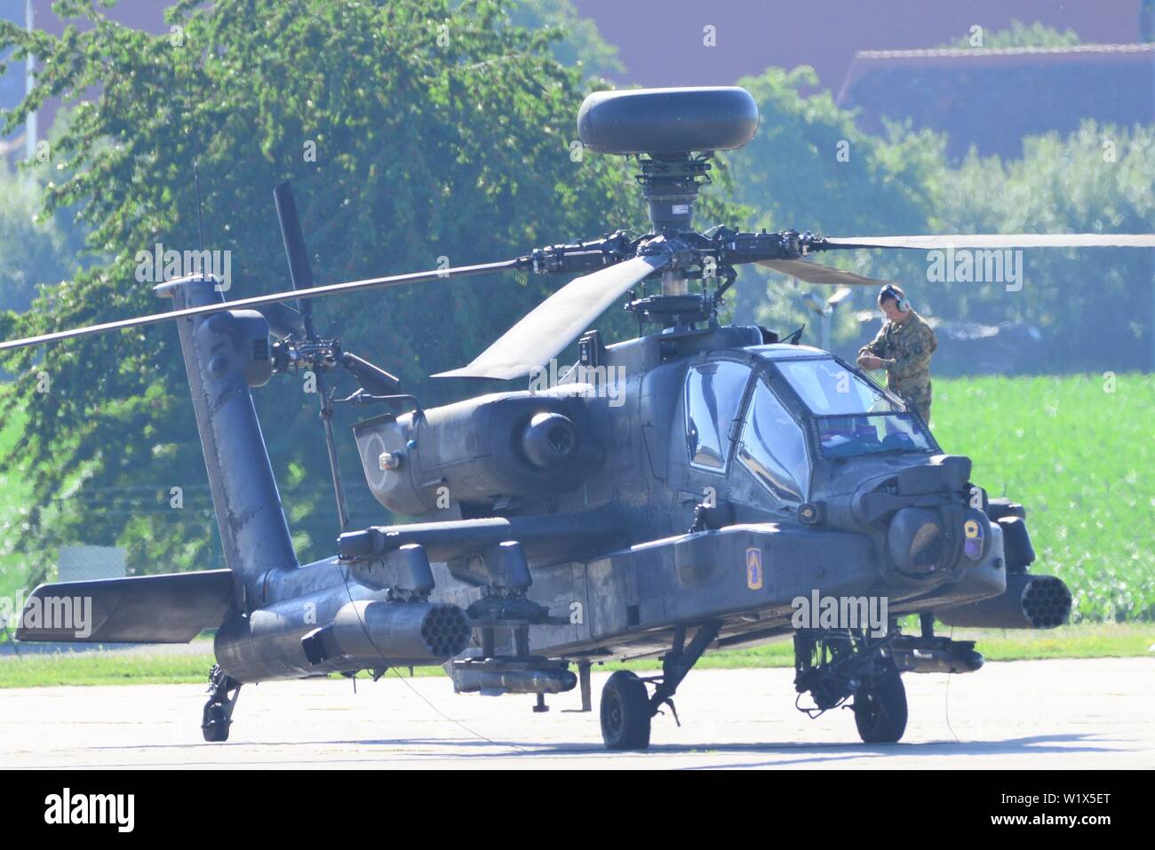 A 12th Combat Aviation Brigade Apache crewmember prefights his aircraft ...
