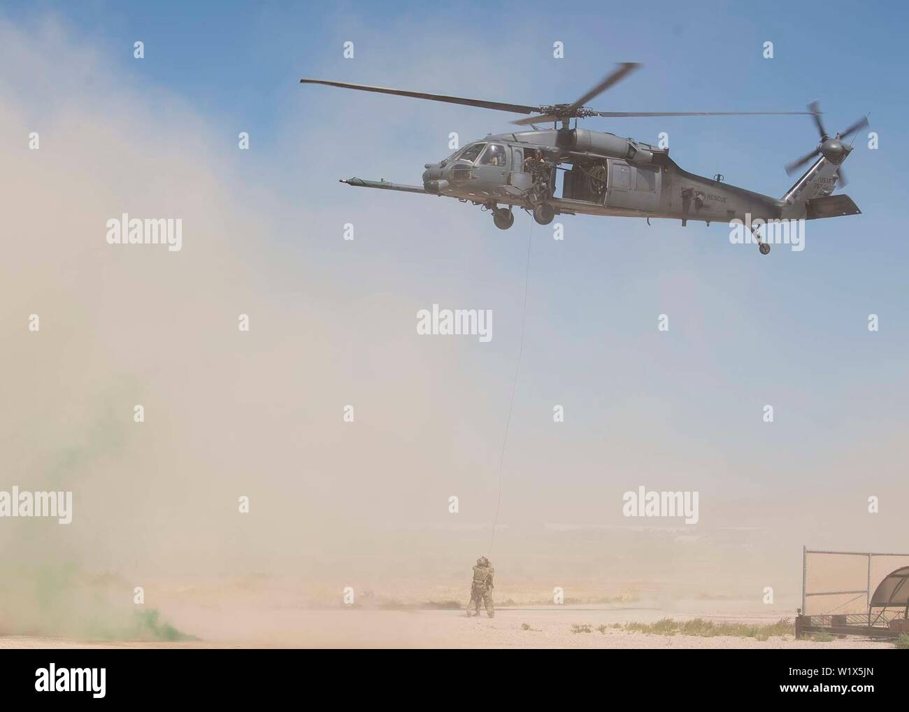 Pararescuemen assigned to the 66th Rescue Squadron repel from an HH-60G ...