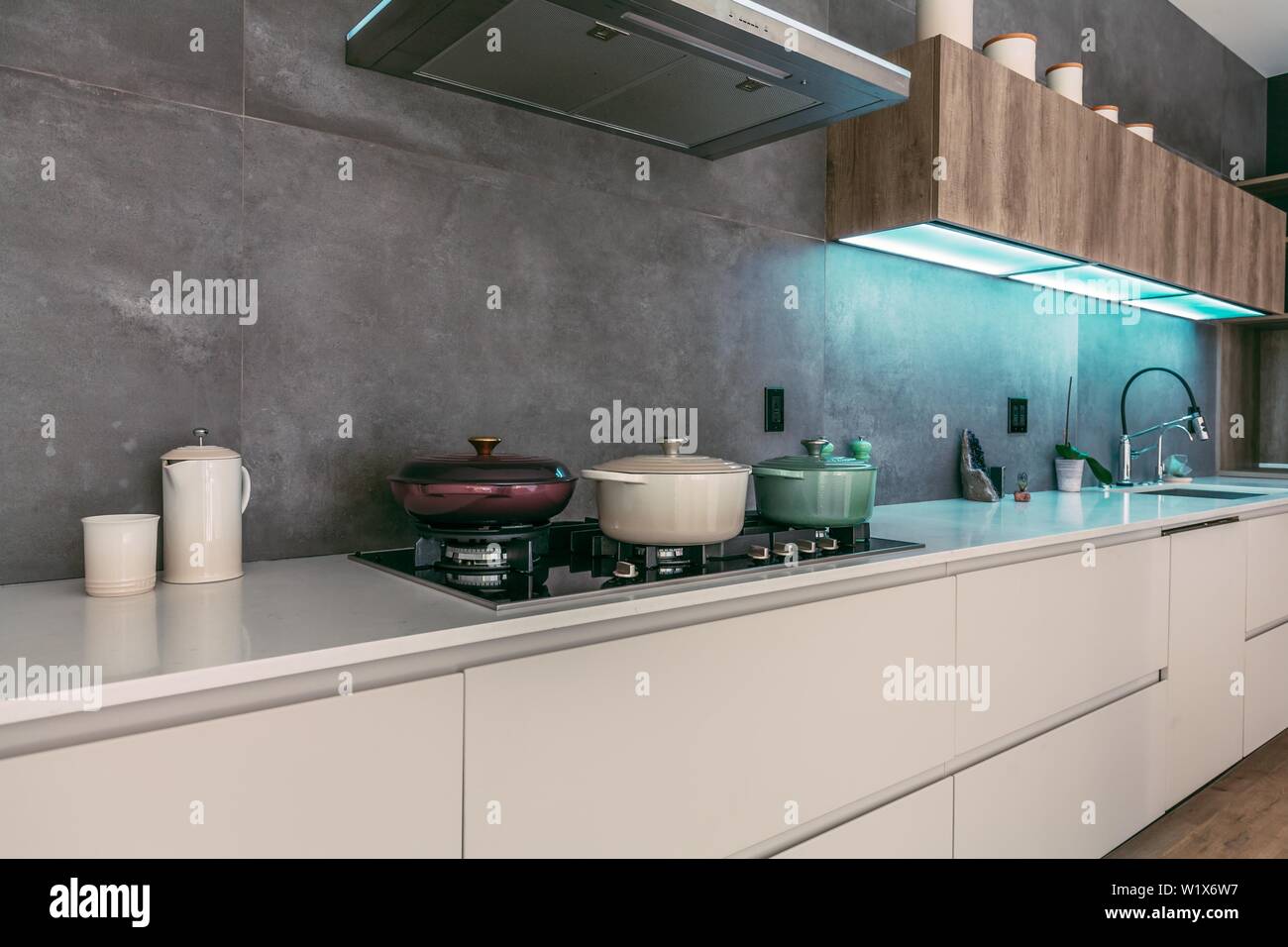 A beautiful interior of a modern kitchen with cooking pots on the oven ...