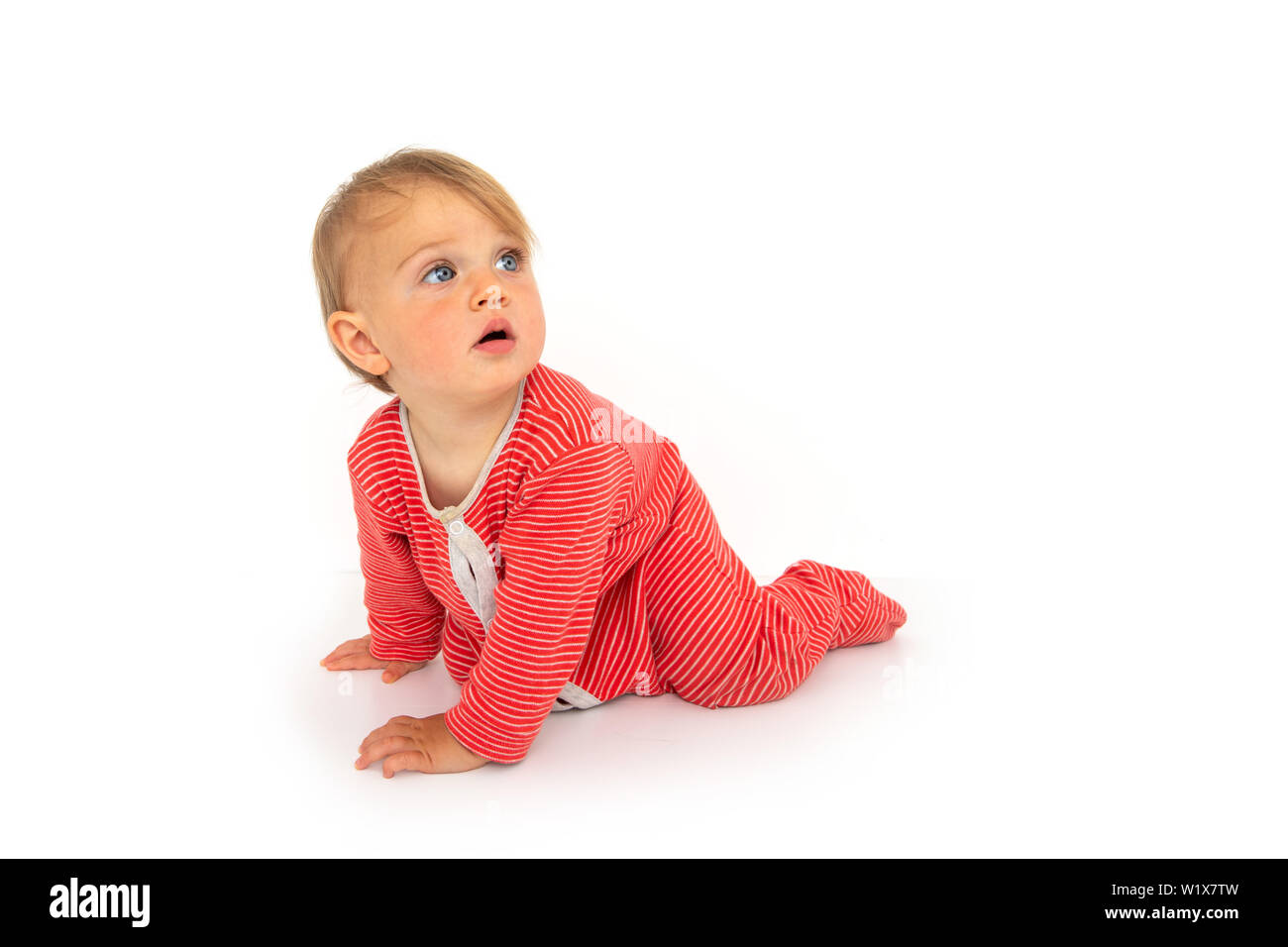 Cute baby in rompers in studio Stock Photo - Alamy