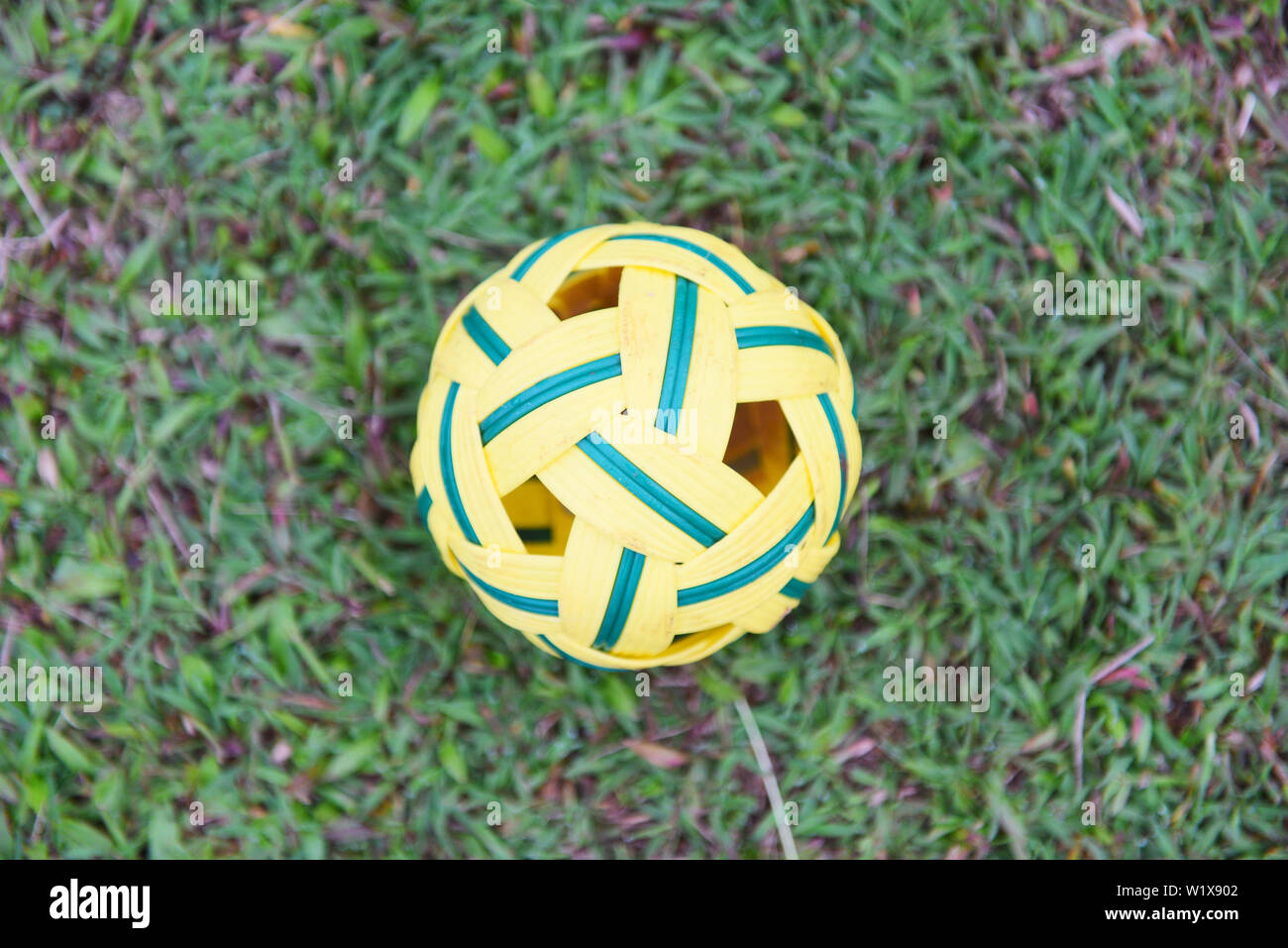 Sepak Takraw ball on green grass field / rattan ball sport outdoor ...