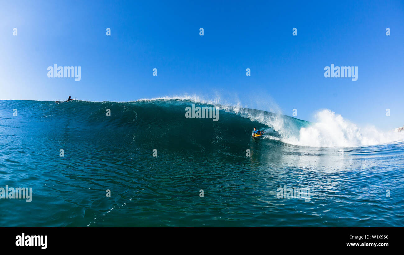 Surfing body boarding rider tube rides hollow ocean wave swimming water ...