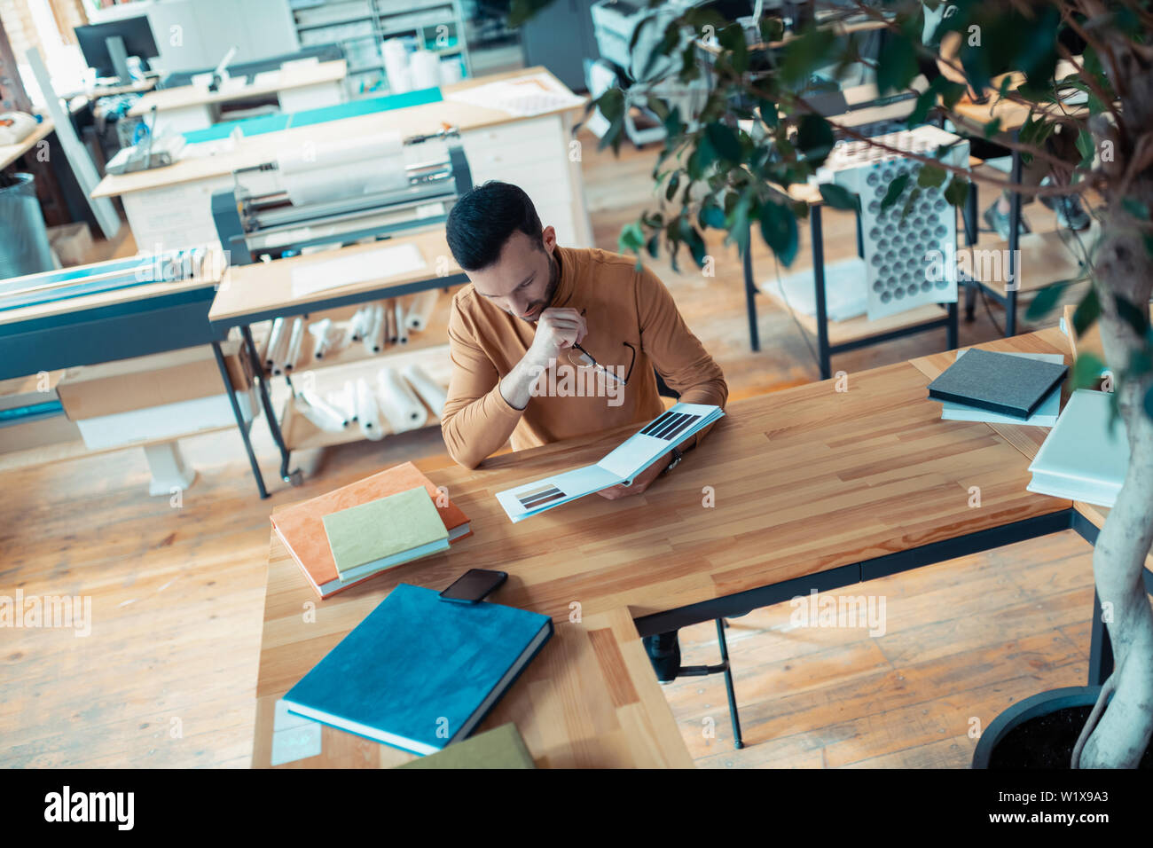 Graphic designer. Bearded handsome graphic designer working in ...