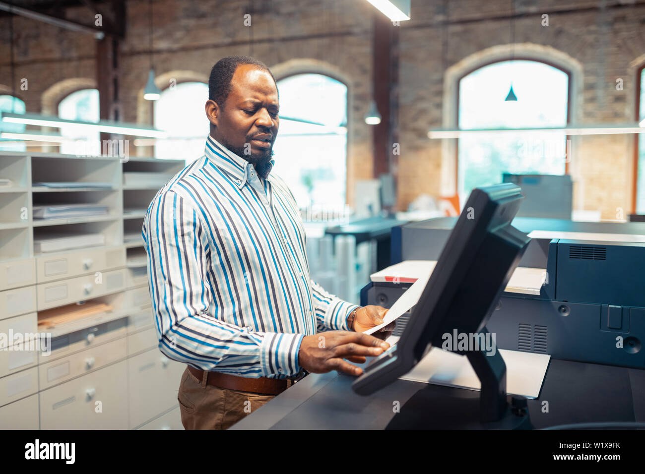 Too much work. Dark-skinned mature man feeling overloaded while having ...