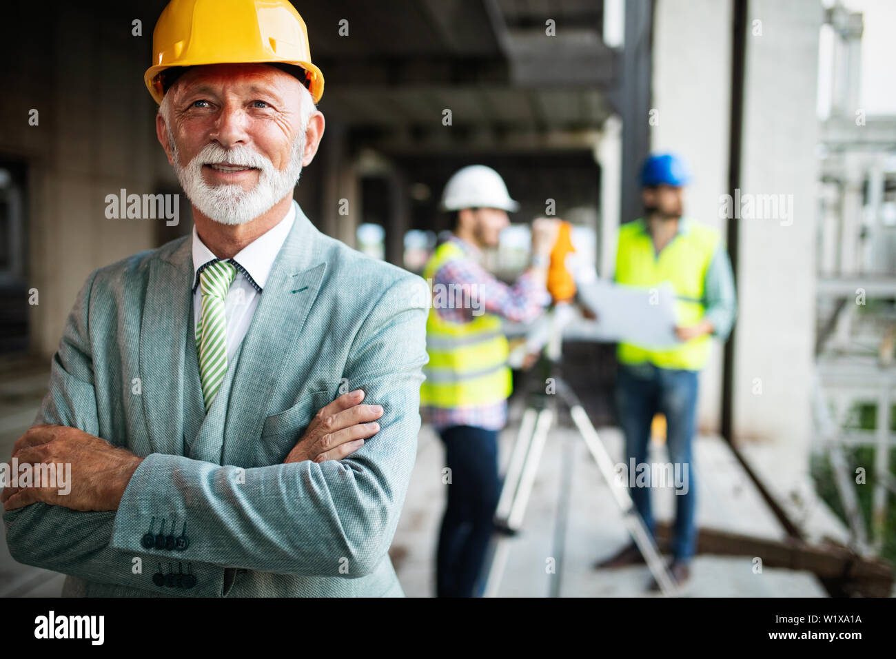 Engineer and construction site manager dealing with blueprints and ...