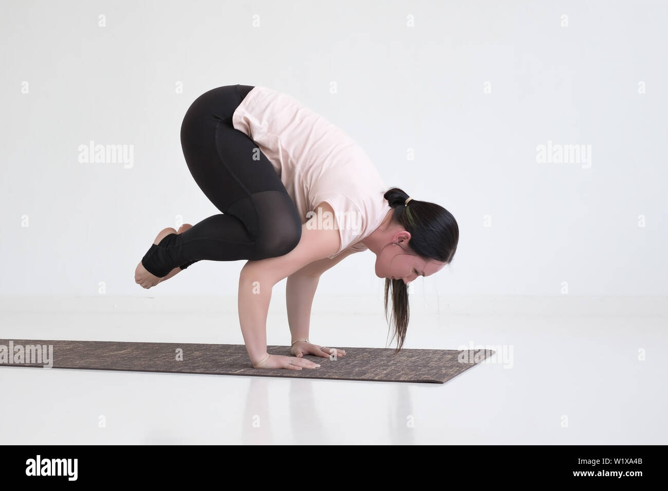 Doing crane pose hi-res stock photography and images - Alamy