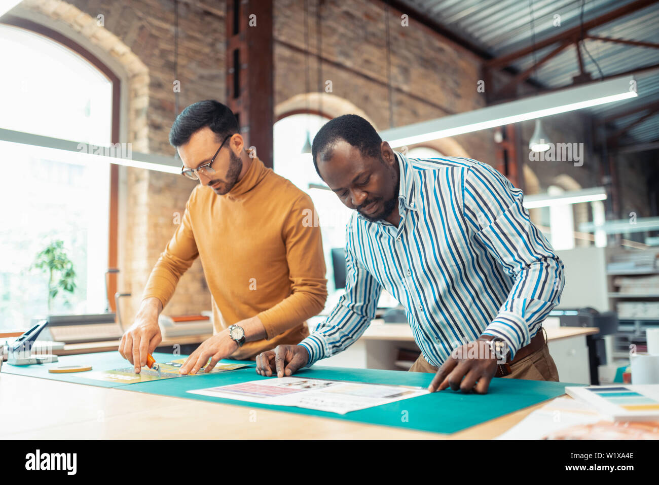 Making some measurements. Two hard-working men making some measurements ...