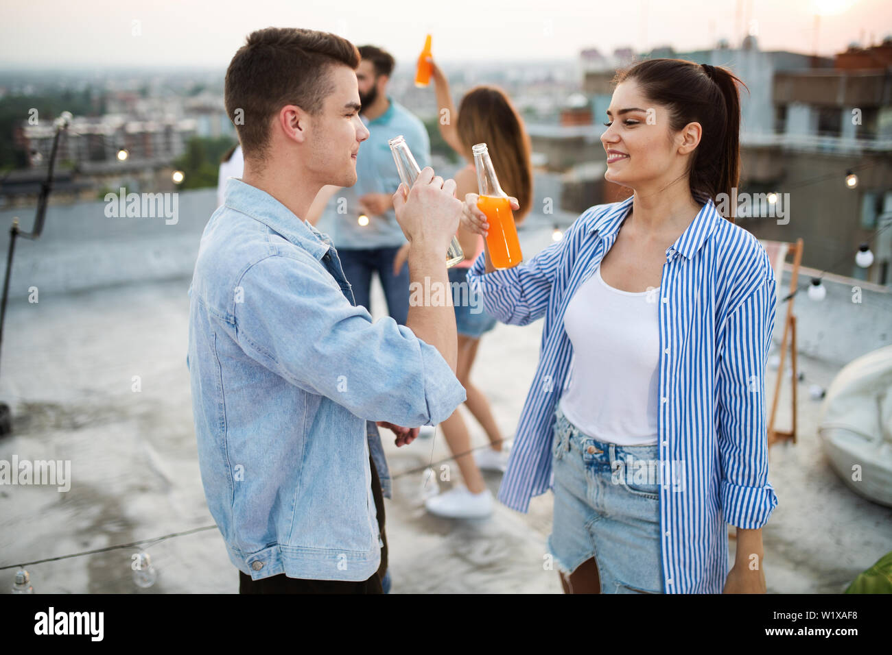 Friends having party on top of the roof. Fun, summer, city lifestyle ...