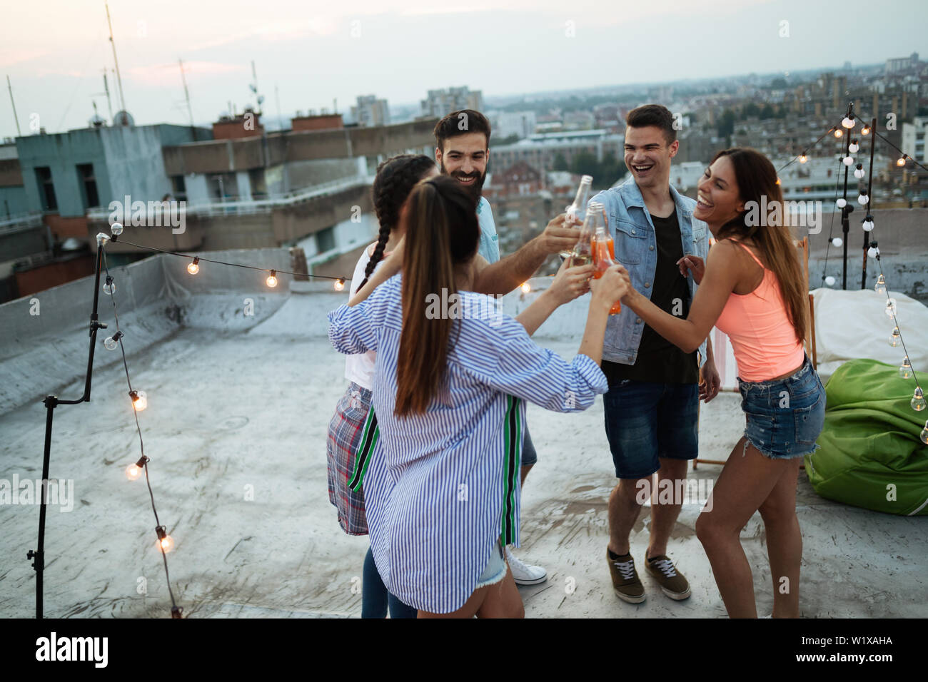 Friends having party on top of the roof. Fun, summer, city lifestyle ...