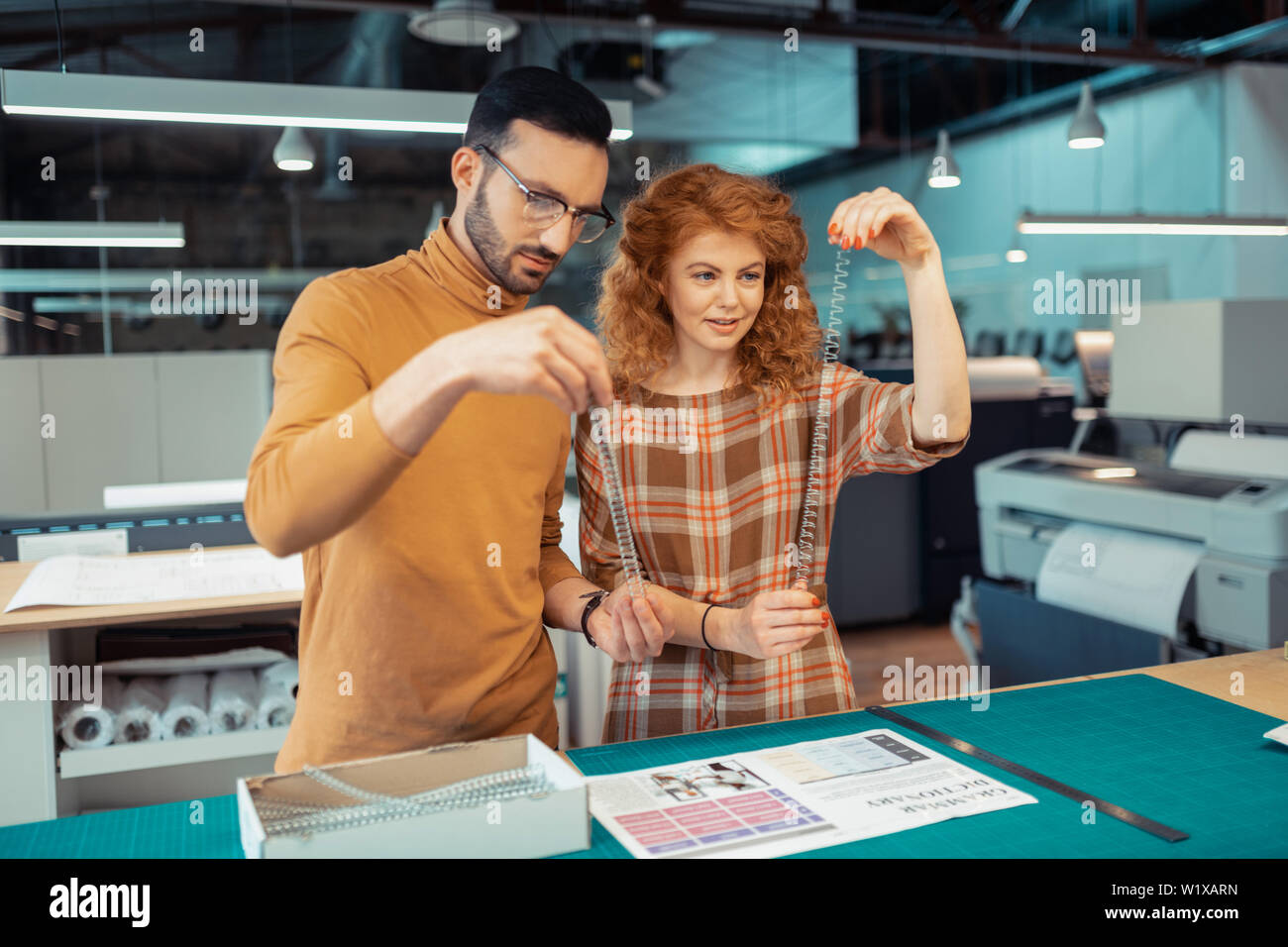 Planning manufacturing. Workers of paper manufacturing office planning ...