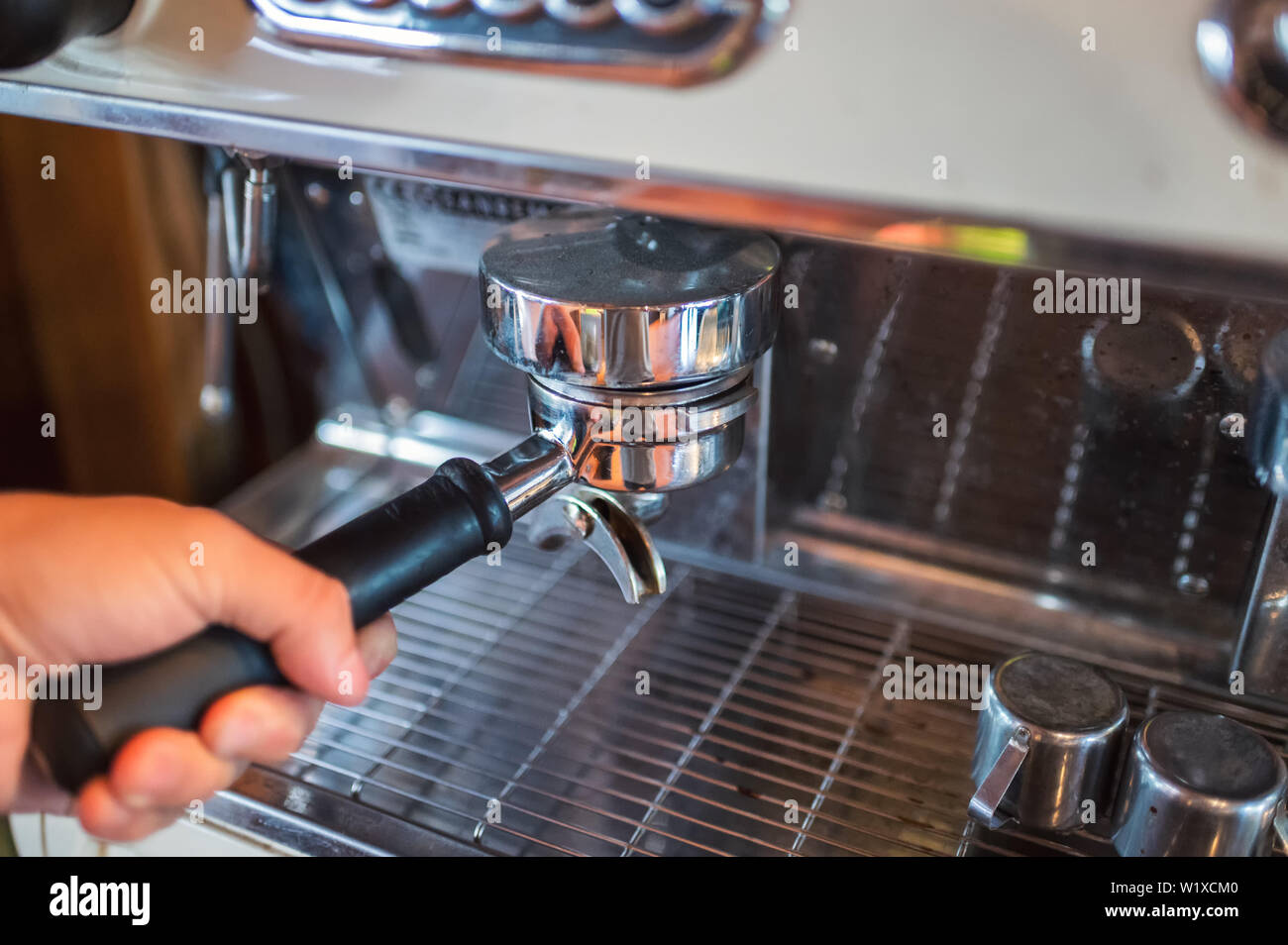 Grinder handle with coffee maker with making espresso Stock Photo - Alamy