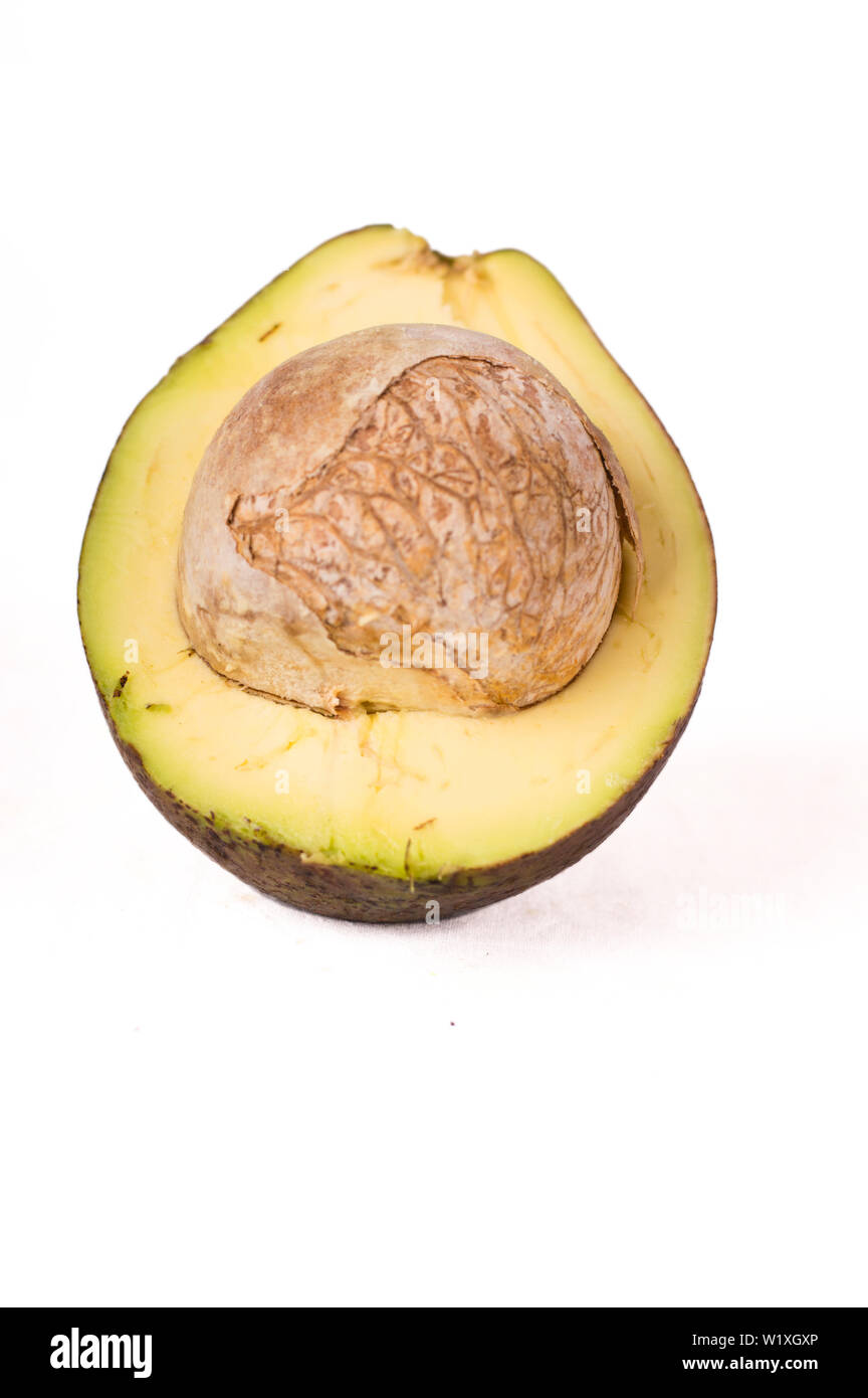 Slice of avocado with its seed inside isolated on white background ...