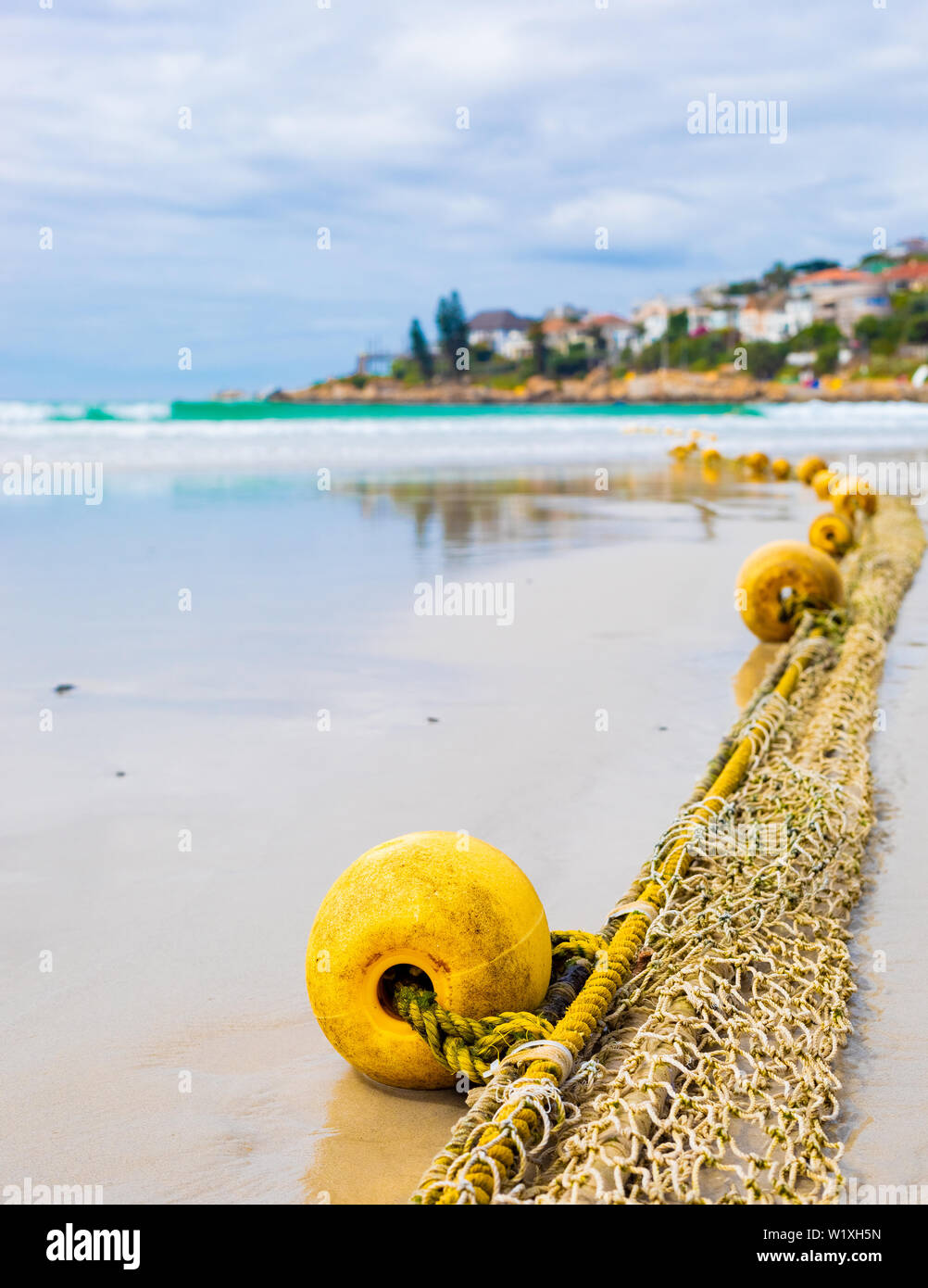 Close-up view of a float of a traditional fishing net on a sandy beach ...