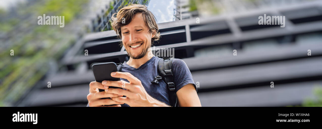 man using map app on smartphone on the background of skyscrapers BANNER ...