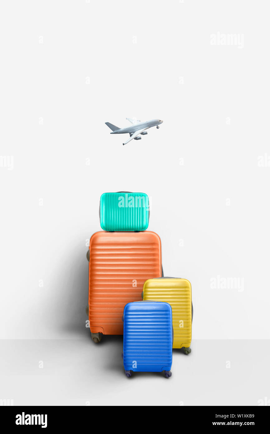 Set of suitcases on pastel colors and flying airplane, on pastel ...