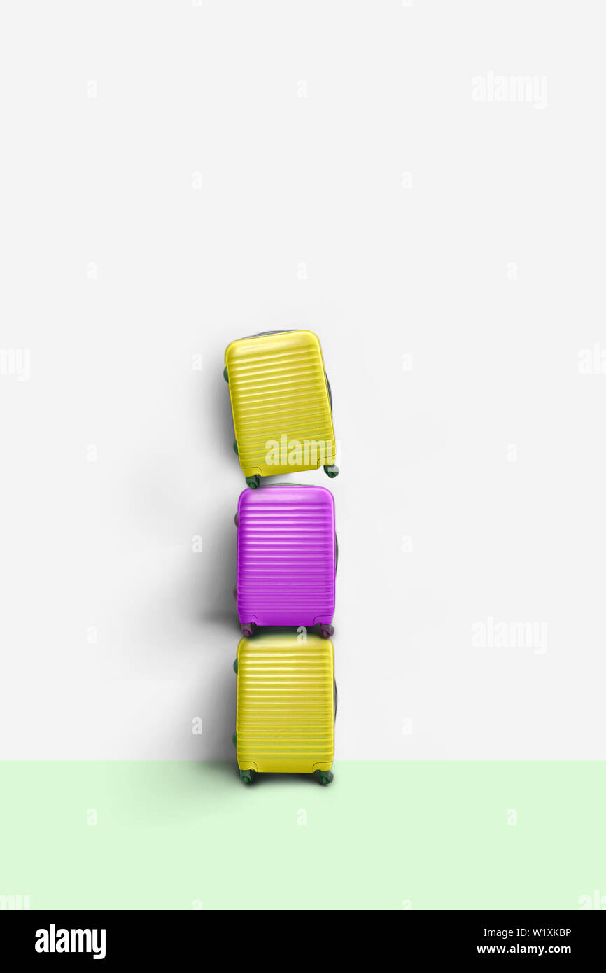 Colorful suitcases stacked, on pastel color background, minimal travel ...