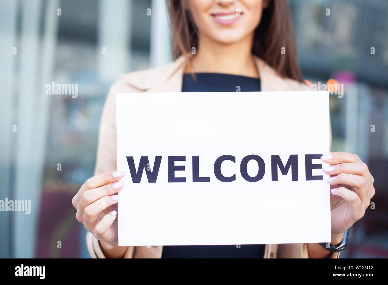 Women business with the poster with welcome message Stock Photo - Alamy