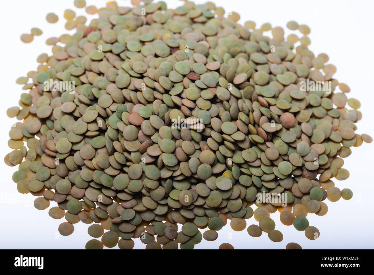 Green lentils on white background Stock Photo - Alamy