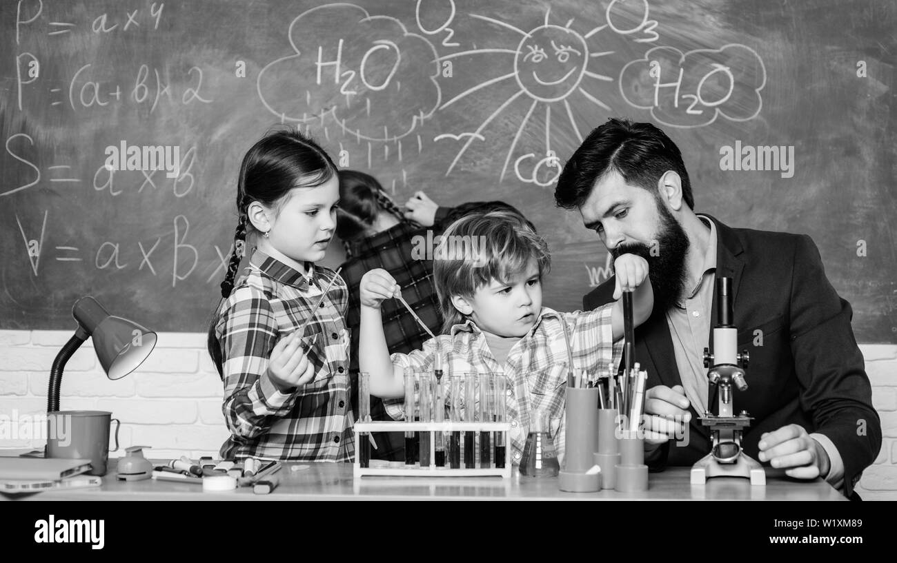 students doing science experiments with microscope in lab. school kids ...