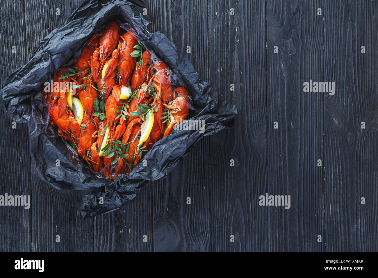 Top view of box with boiled crawfish on rustic wooden background Stock ...