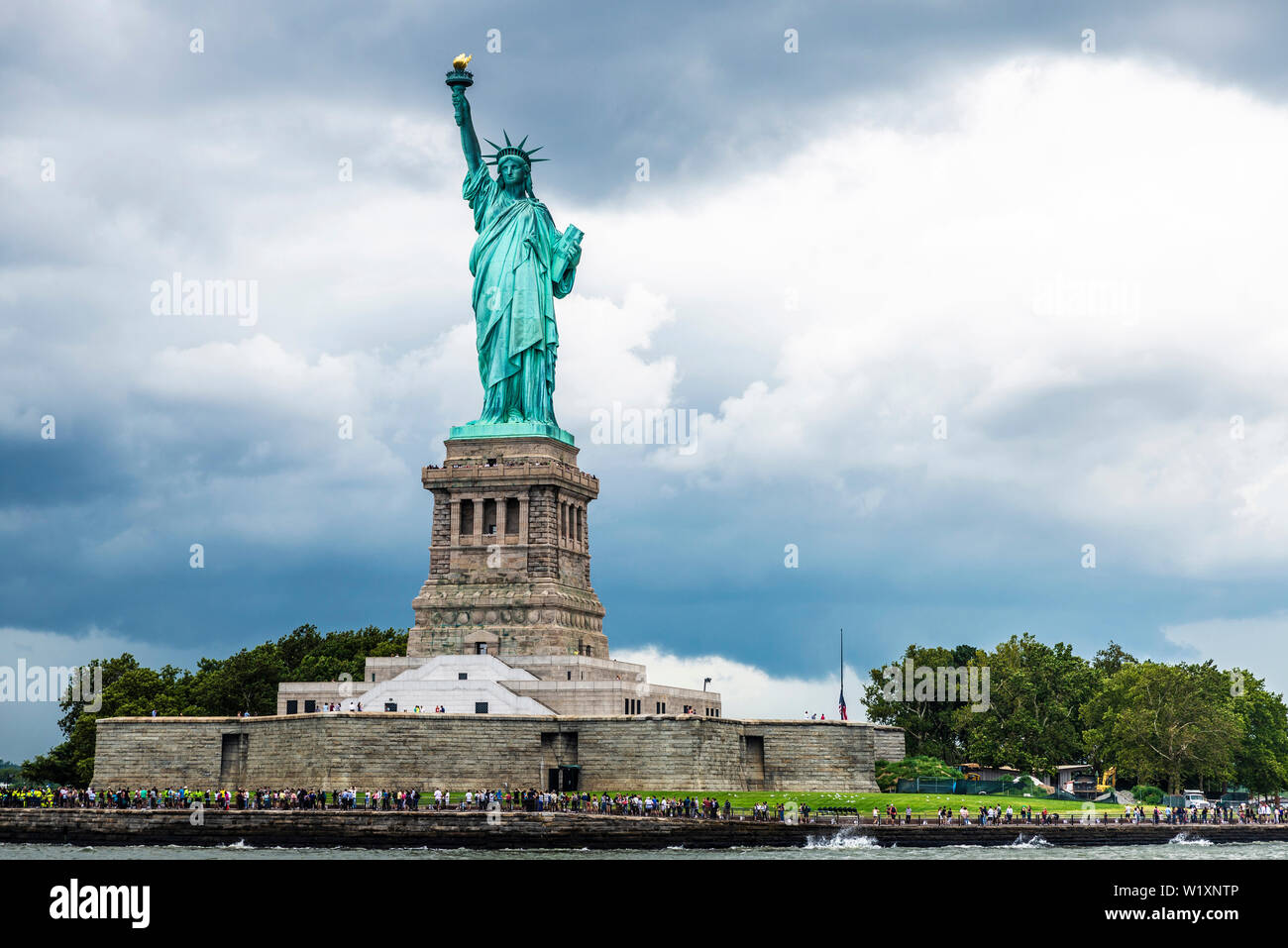 View of the Statue of Liberty with people around in New York City, USA ...