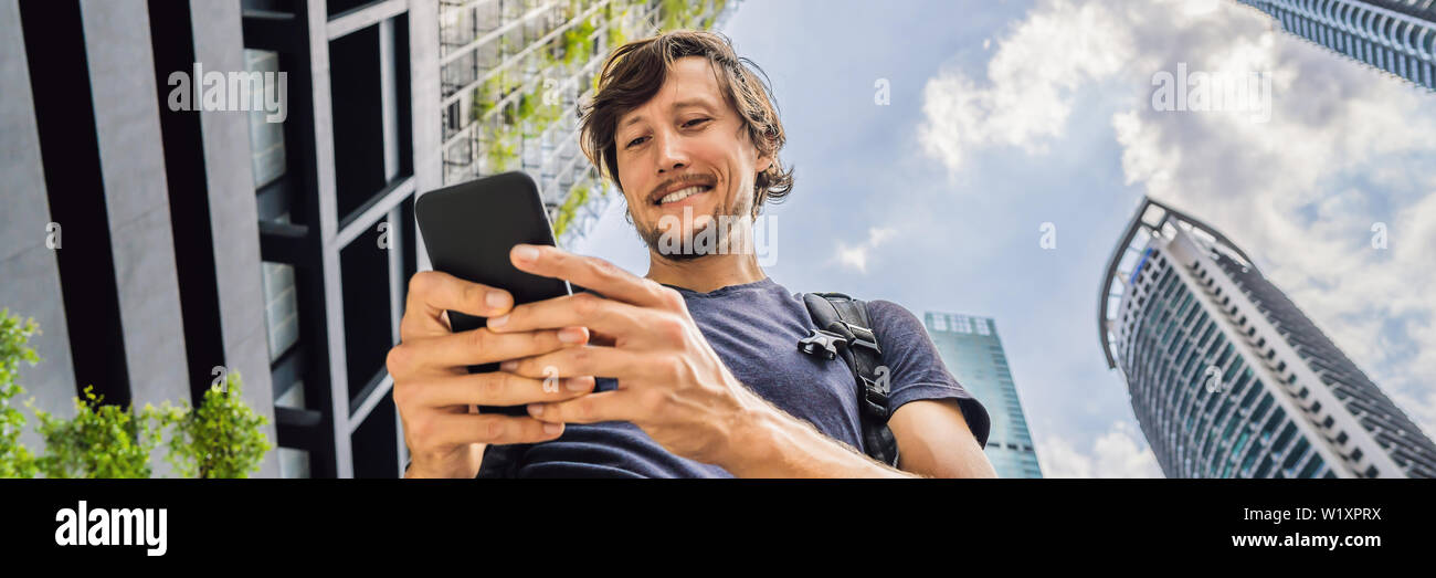 man using map app on smartphone on the background of skyscrapers BANNER ...