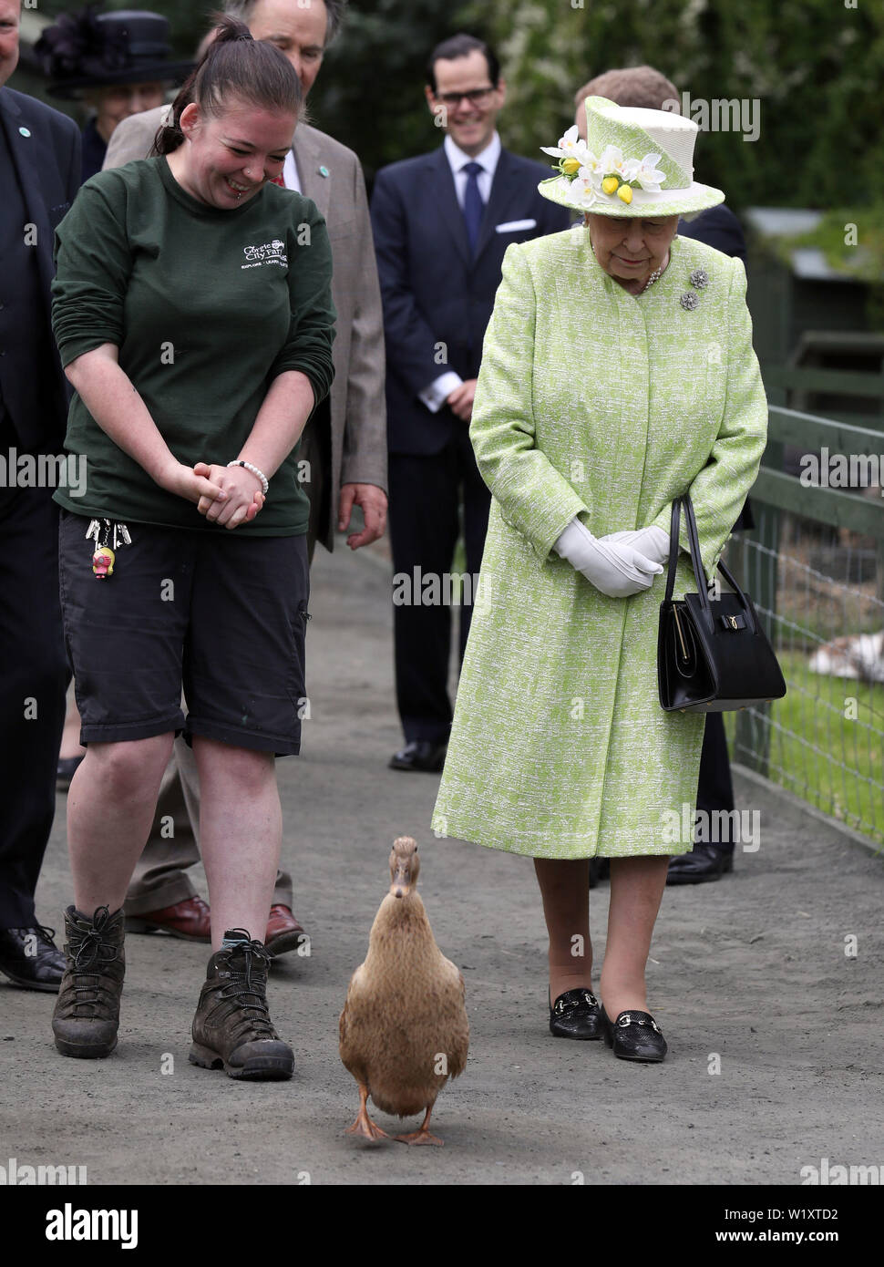 Queen Elizabeth II with keeper Maia Gordon as Olive the duck walks ...