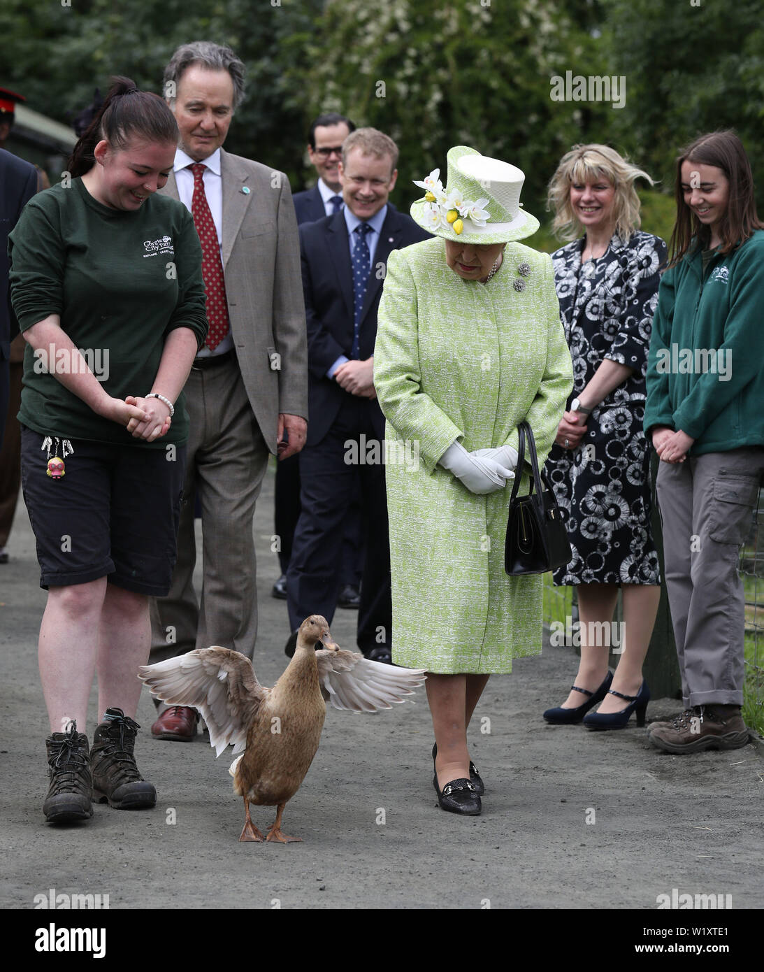 Queen Elizabeth II with keeper Maia Gordon as Olive the duck walks ...
