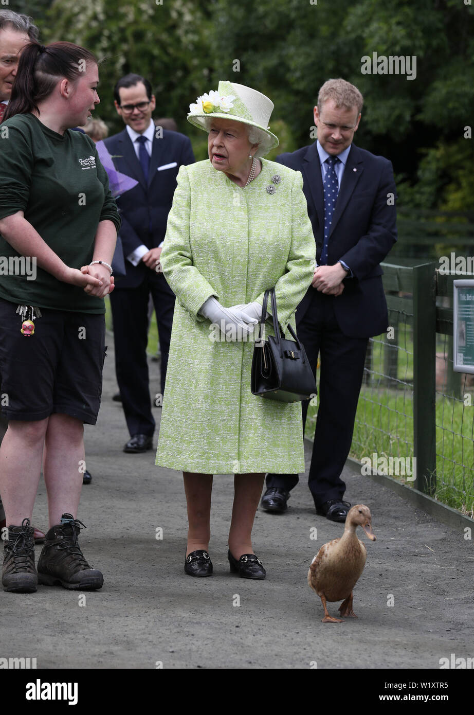 Queen Elizabeth II with keeper Maia Gordon as Olive the duck walks ...
