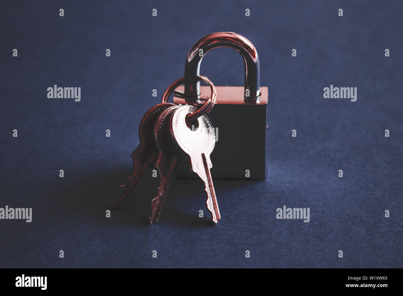 Silver metal check lock and three keys on dark blue background. Modern ...