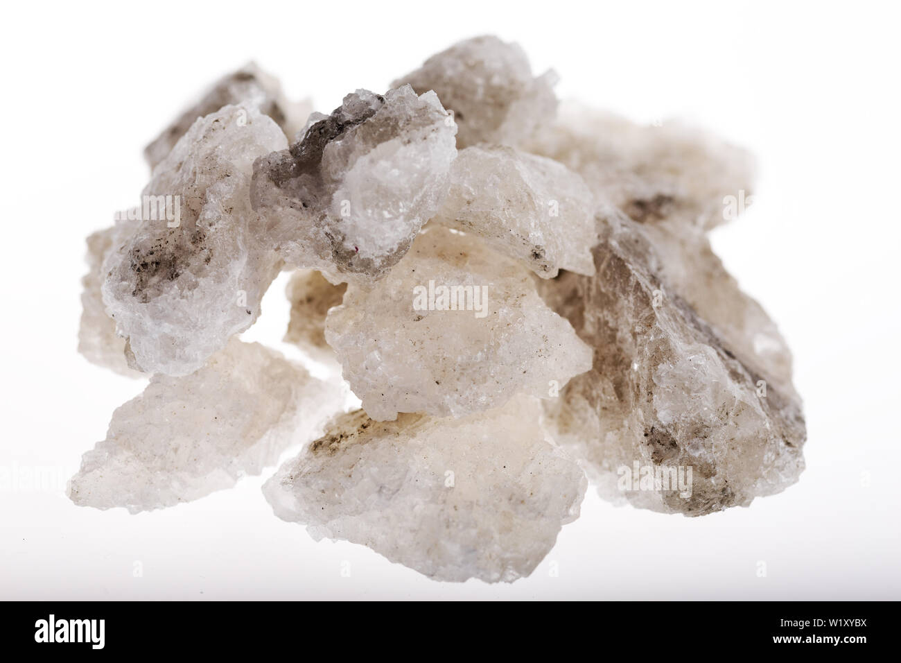 Rock salt on white background Stock Photo - Alamy
